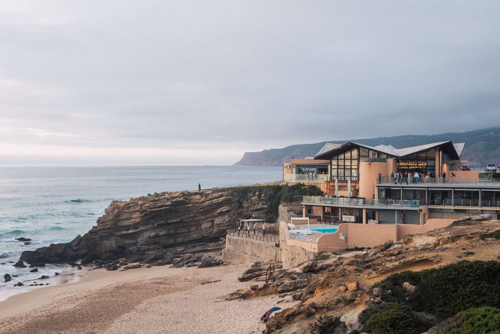 Modern glass pavilion with panoramic Cascais views and sunlit terraces